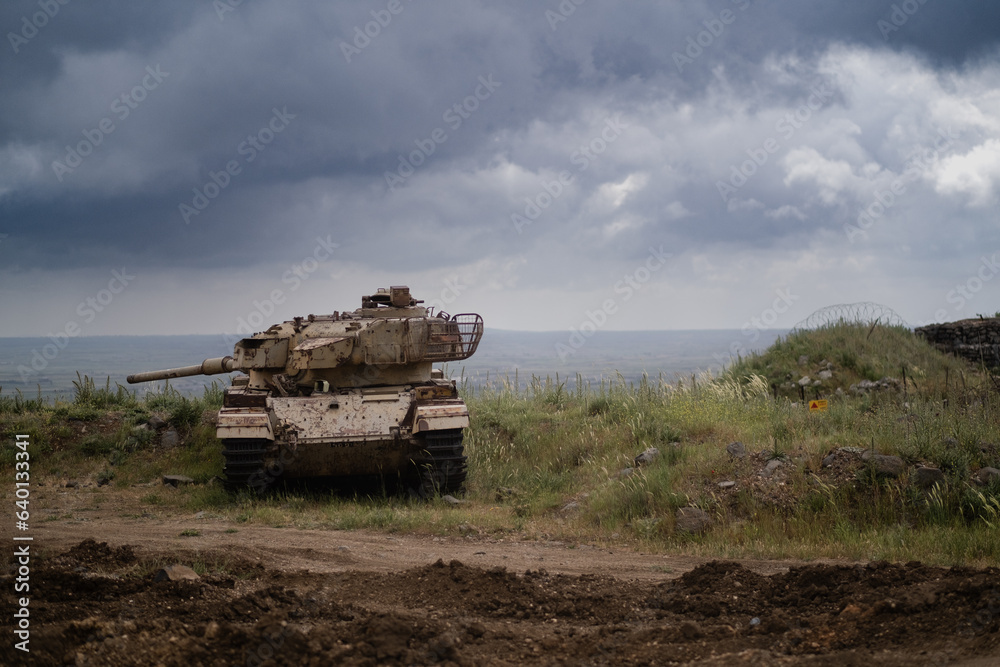On a hilltop in the Golan Heights, an old, rusty tank sits disused, a ...