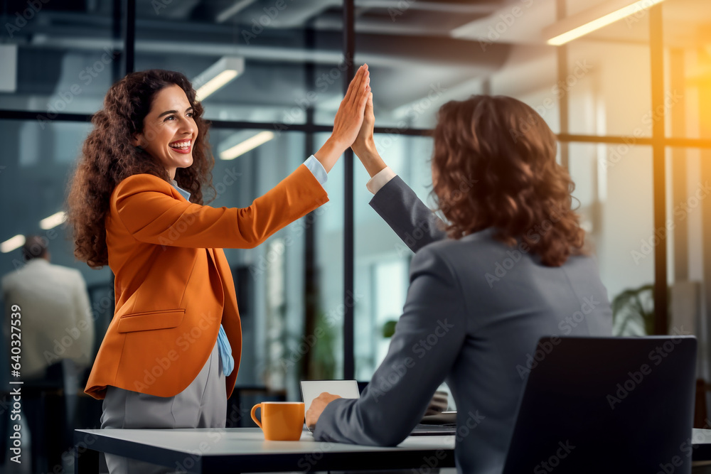Successful business women giving high five. Two young businesswomen ...