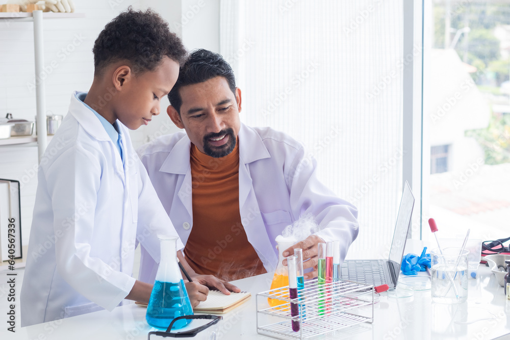 Hispanic or Indian teacher wearing lab coat teaching curiosity African ...