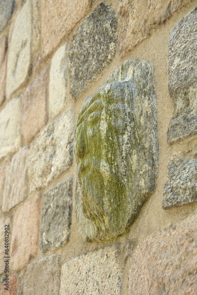 Engravings and bas-reliefs depicting grotesque human and devil masks on ...