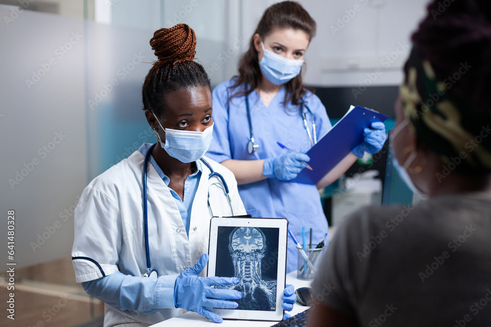Radiologist and nurse delivering medical exam results to patient using ...