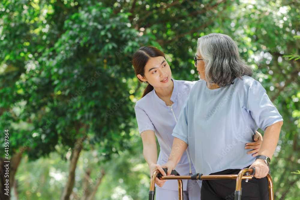 Elderly women using walking aids for exercises to improve muscle ...
