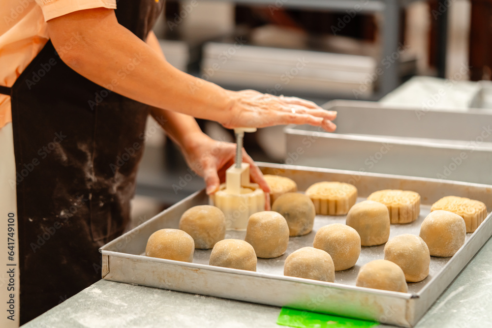 Mooncake making process. A mooncake is a Chinese bakery product ...