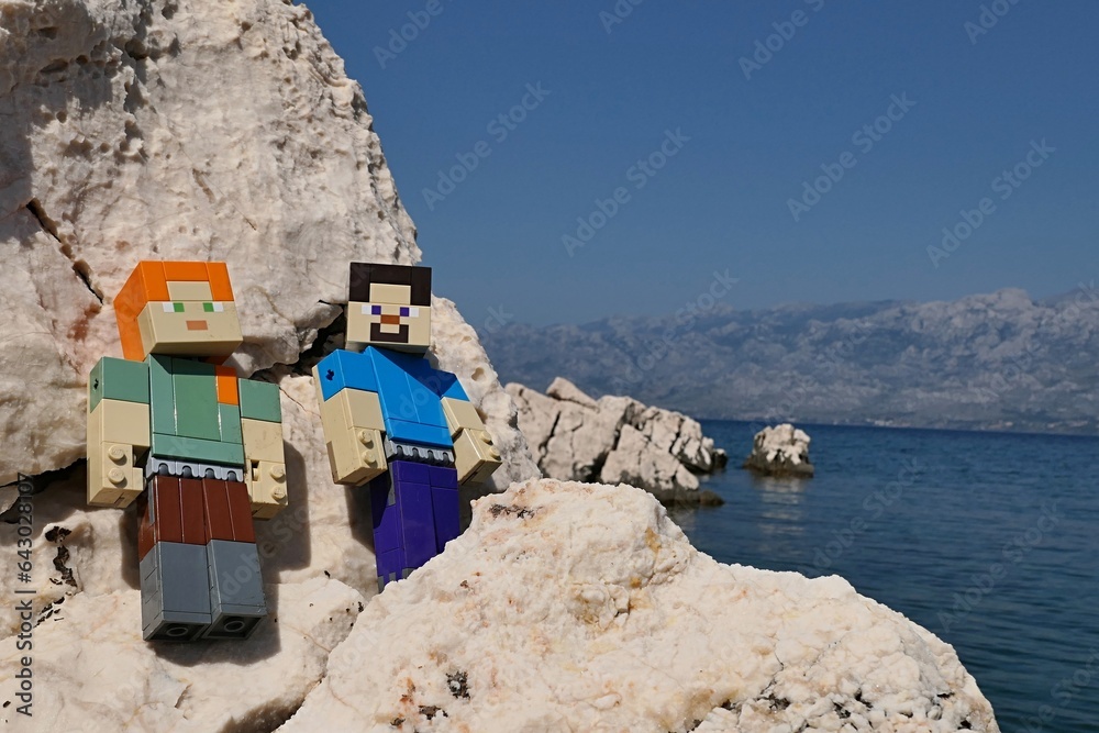 LEGO Minecraft main characters Alex and Steve standing on rocks sunlit ...