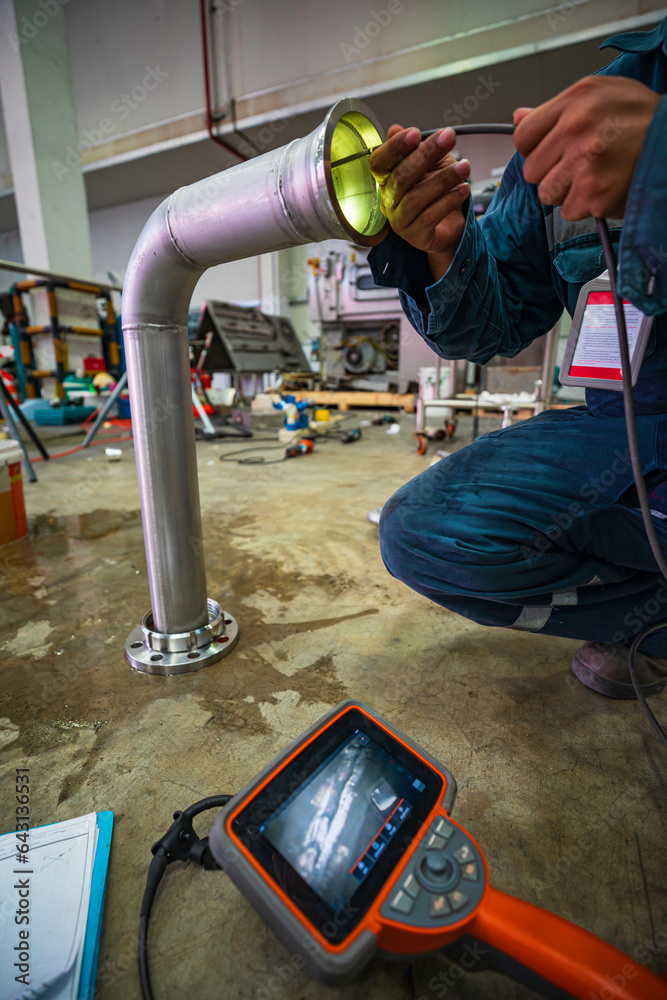 A man starts using a weld pipe stainless inspection camera. The light ...