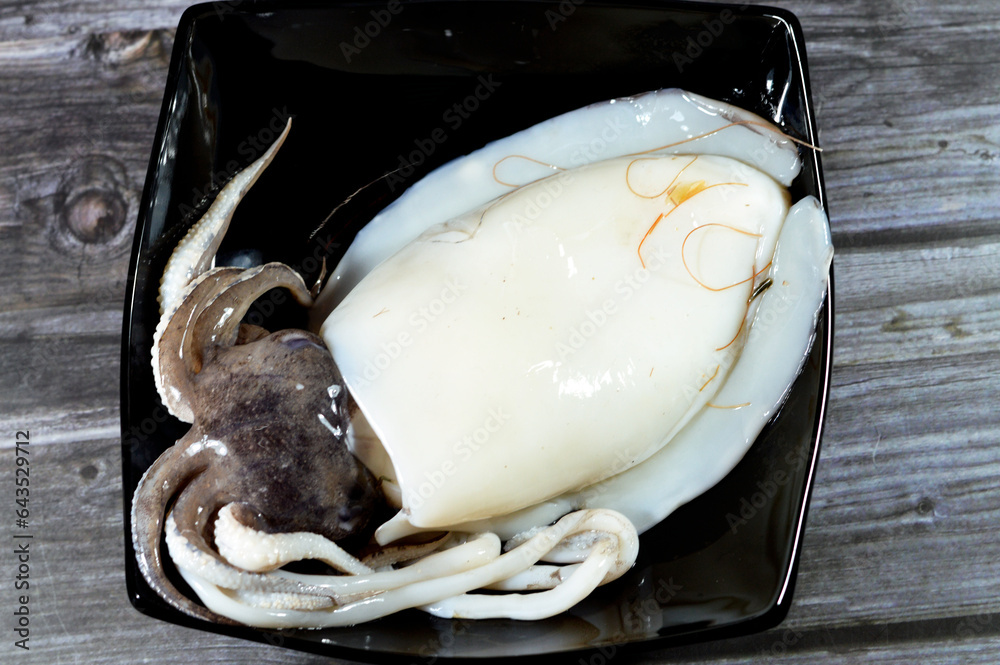Fresh raw uncooked squid, a mollusc with an elongated soft body, large ...