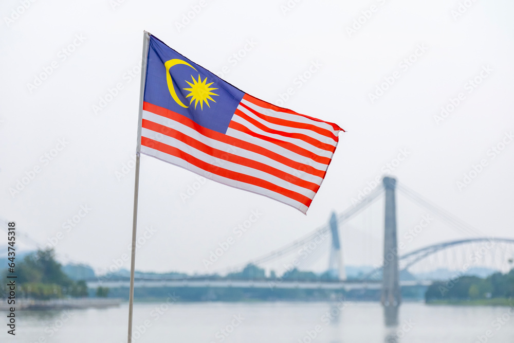 The Malaysia flag is also known as Jalur Gemilang waving with a city in ...