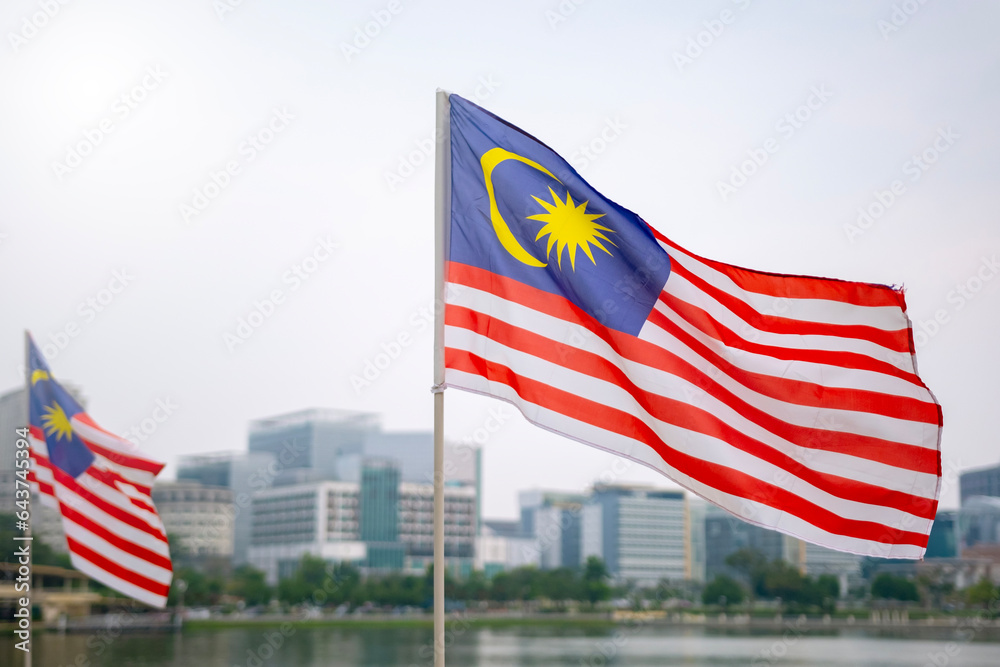 The Malaysia flag is also known as Jalur Gemilang waving with a city in ...