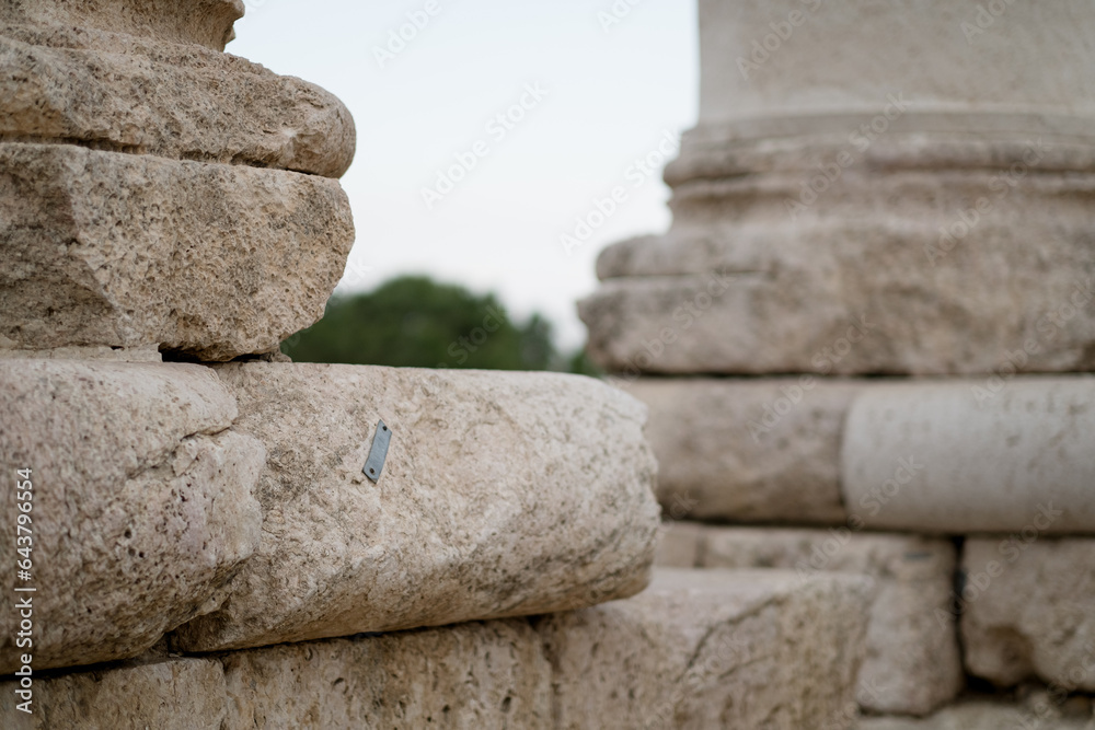 At the base of a monumental marble column, architectural details are ...