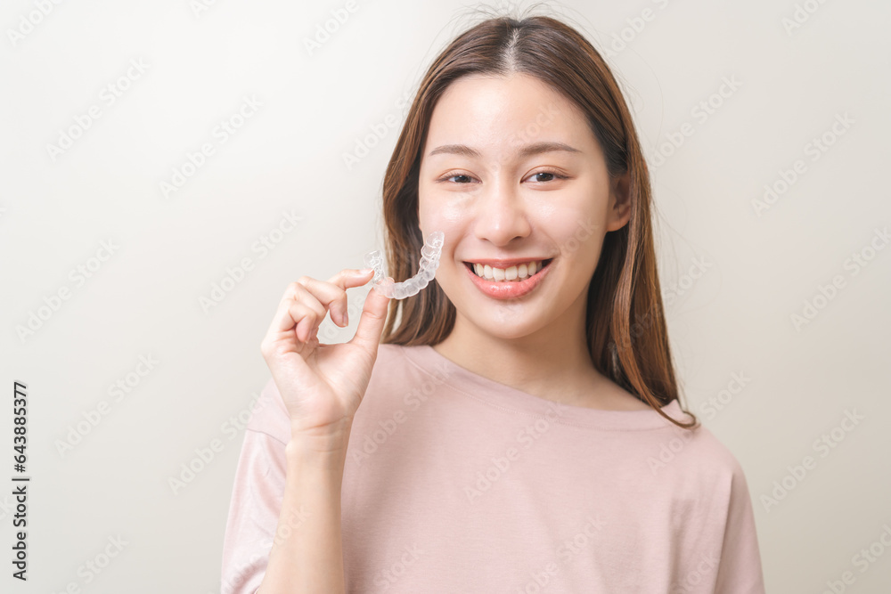 Dental invisible braces, beautiful smiling asian young woman holding ...