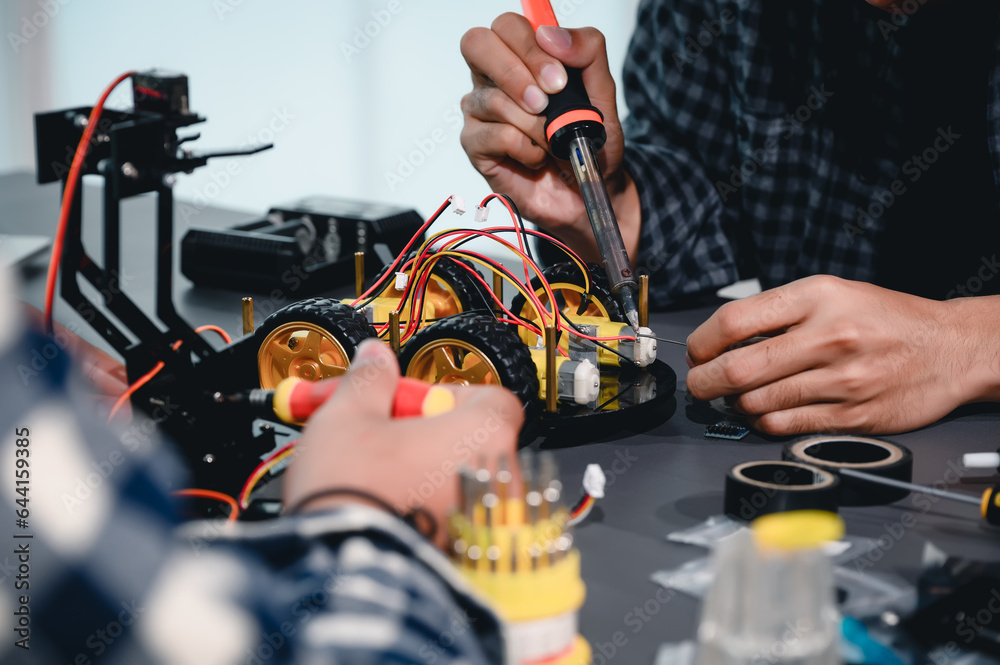 Stock-Foto „Engineer Asian Students Assembling Robotics Kits. Learning Mechanical Control ...