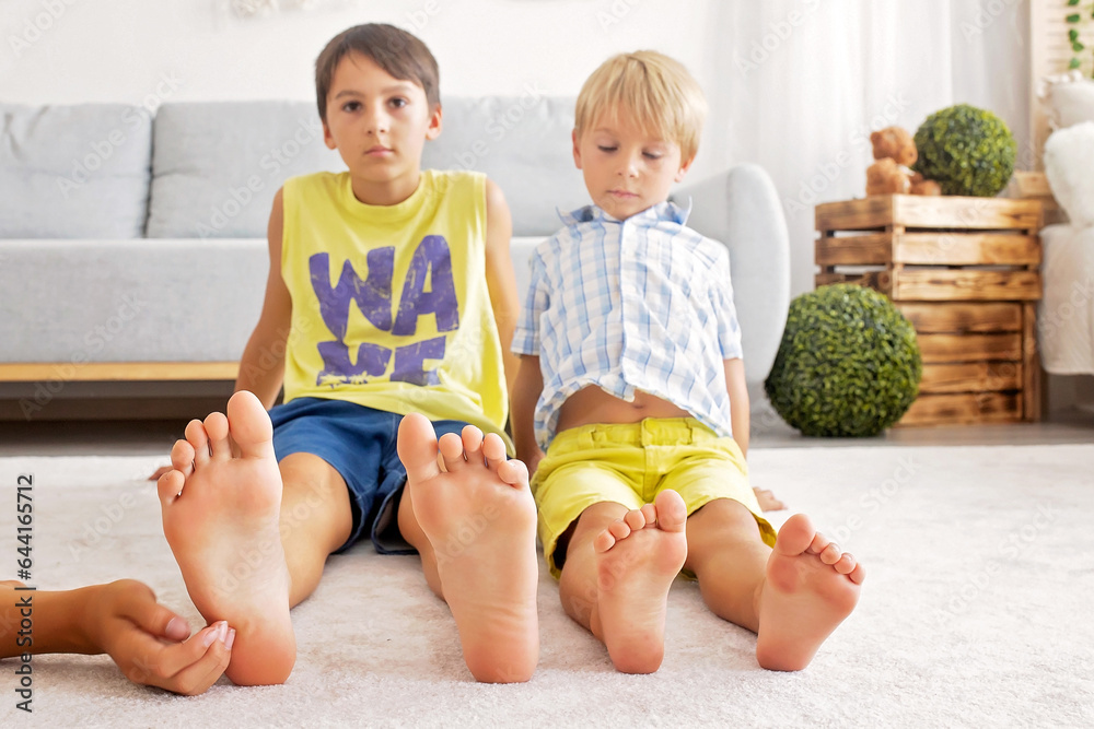 Happy positive children, tickling on the feet, having fun together, boy ...