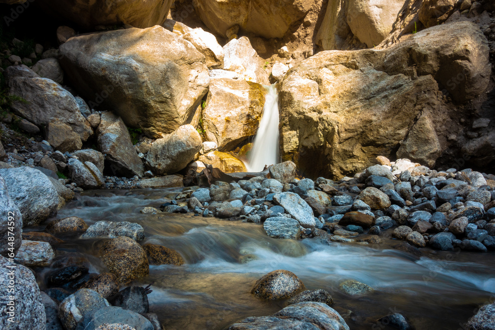 Scenic Himalayan waterfall amid massive rocks in Himachal Pradesh ...