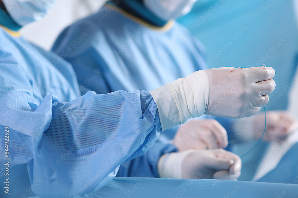 Surgeons' hands in close-up during surgery.Surgery on blood vessels ...