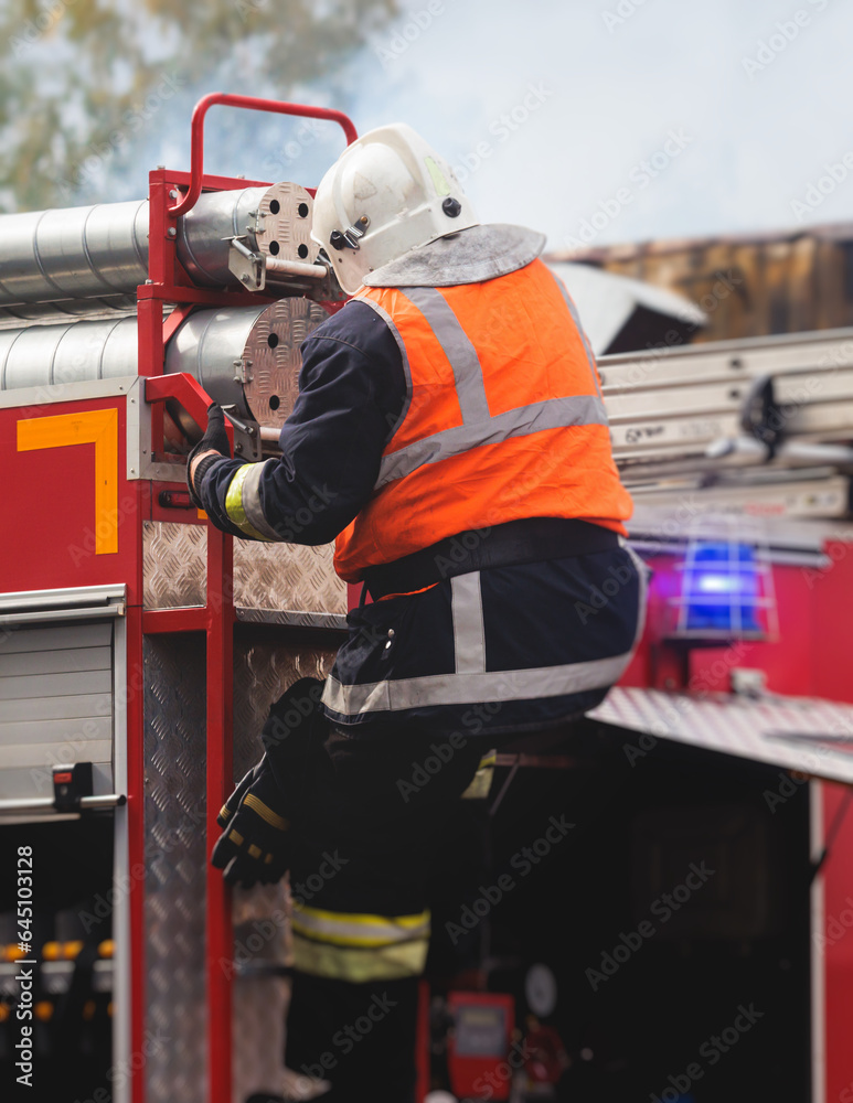 Group of fire men in protective uniform during fire fighting operation ...