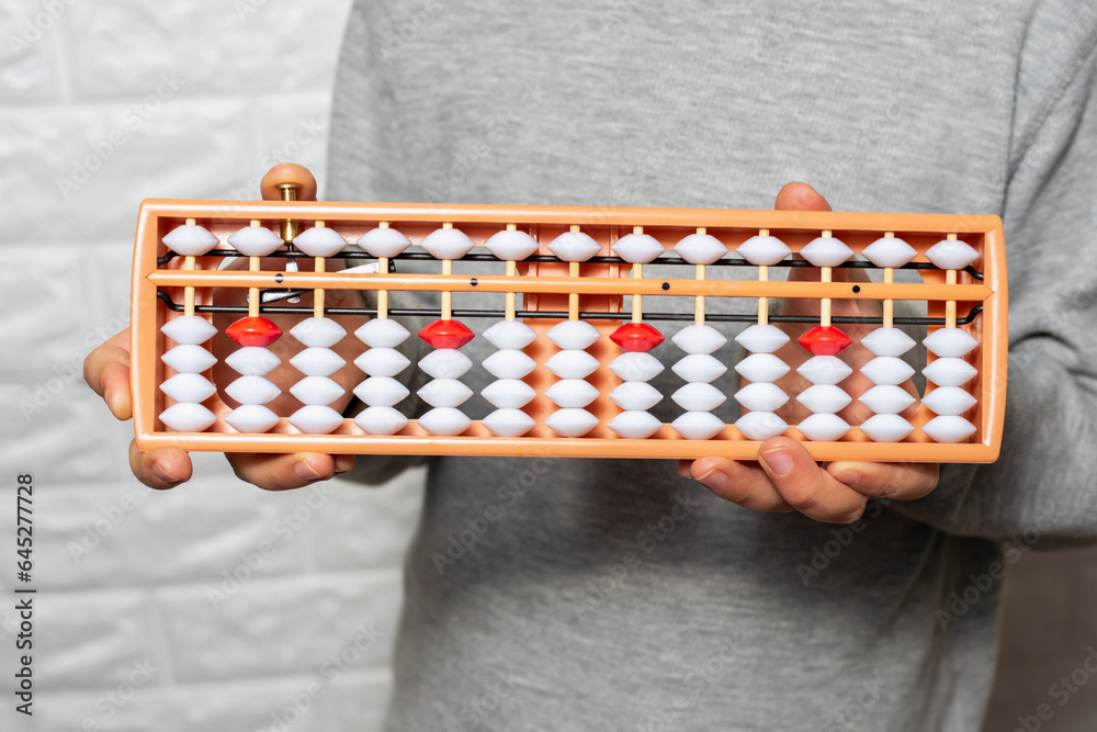 Child boy with Japanese traditional abacus soroban on white background ...