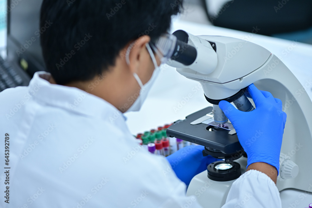 Medical Science Laboratory: Portrait of a scientist looking under a ...