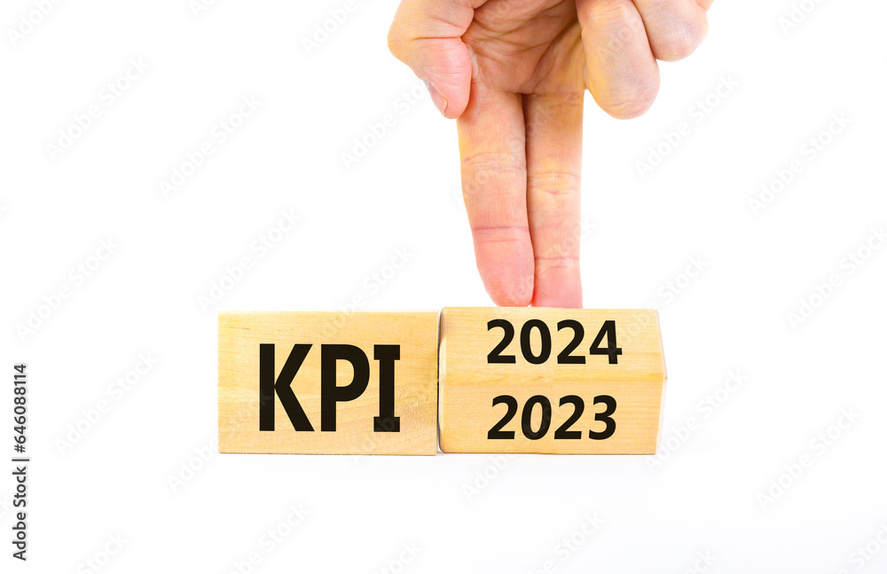 KPI, key performance indicator symbol. Businessman turns wooden cubes ...