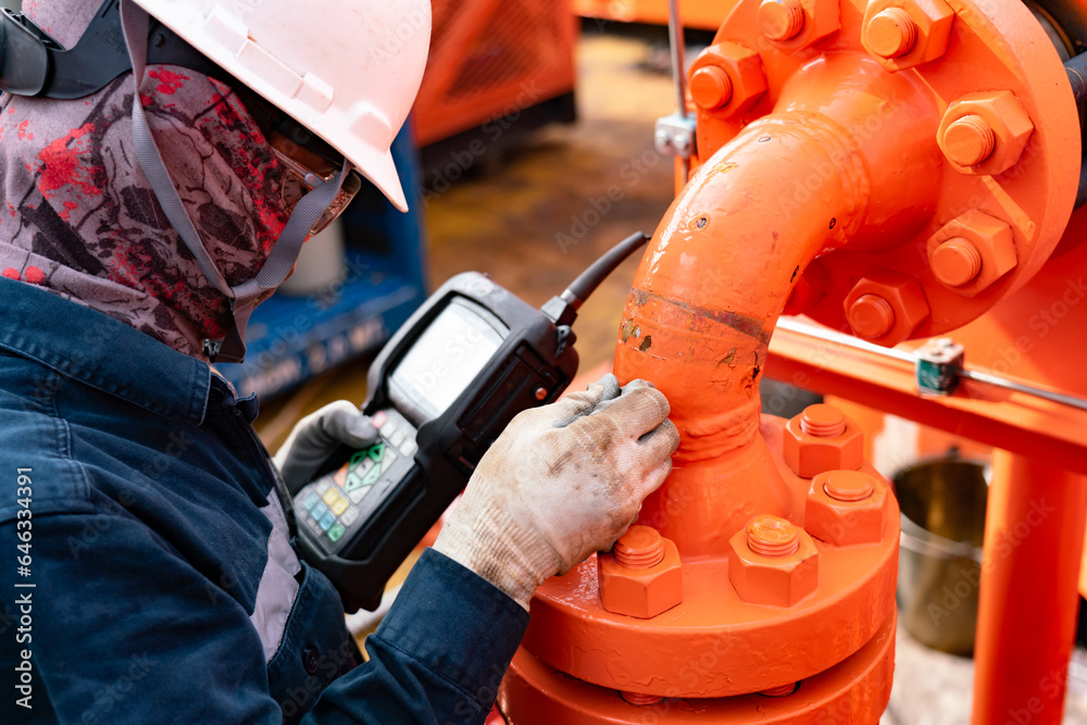 Non-destructive testing technicians are checking the thickness of elbow ...