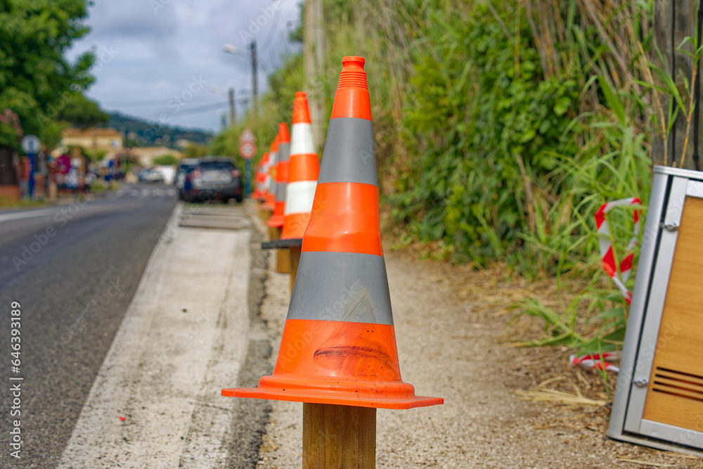 Pylons at road construction site with installation of wooden crash ...