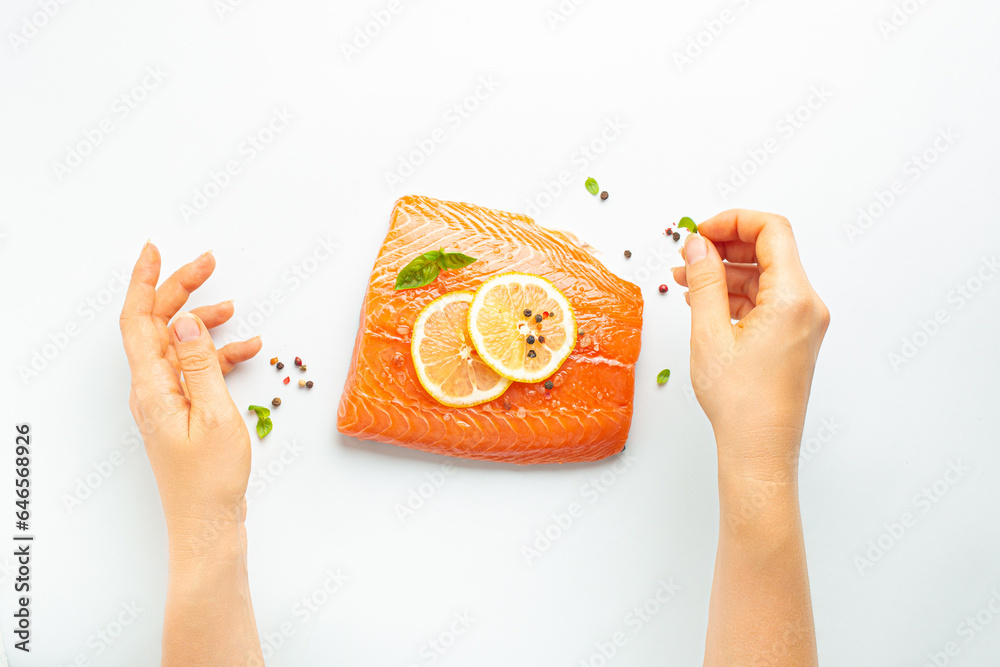 Female hands seasoning fresh raw salmon marbled fillet isolated on ...
