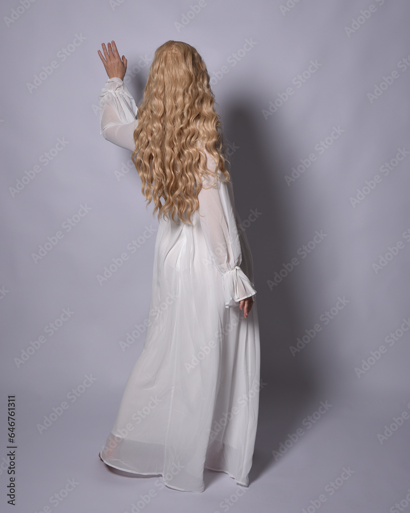 Full length portrait of blonde woman wearing white historical bridal ...