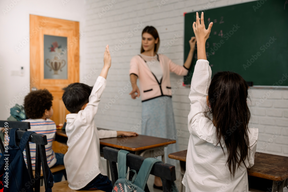 Children raise their hands to answer in the classroom. Back To School ...