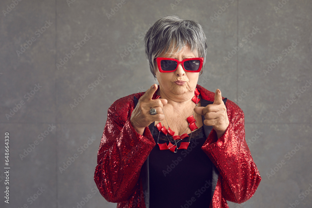 Goofy old grandma in disco costume makes funny face and points at you ...