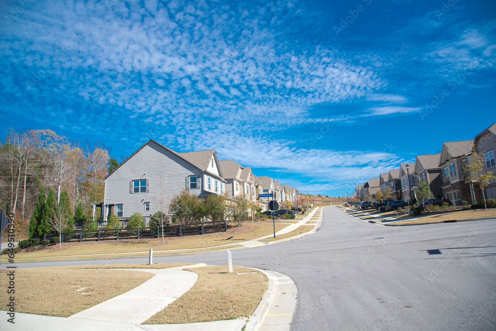 Intersection of large residential streets with row of upscale new ...