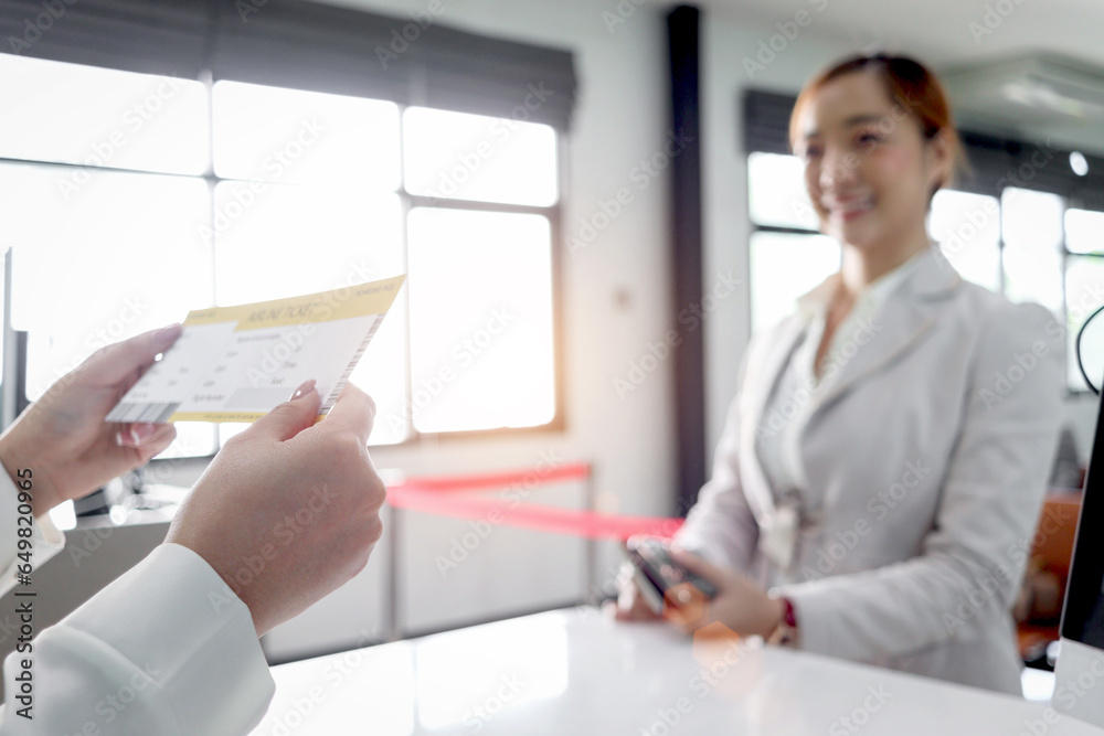 Hand of passenger service agent staff receiving boarding pass from ...