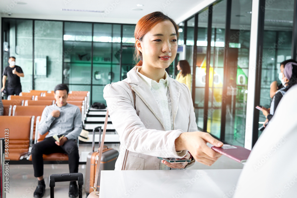 Beautiful Asian female traveler gives passport boarding pass to ...