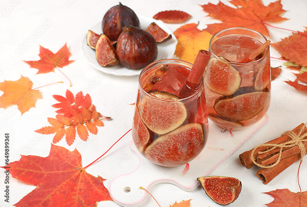 Cocktail with figs, cinnamon, grapes on a light background with autumn ...