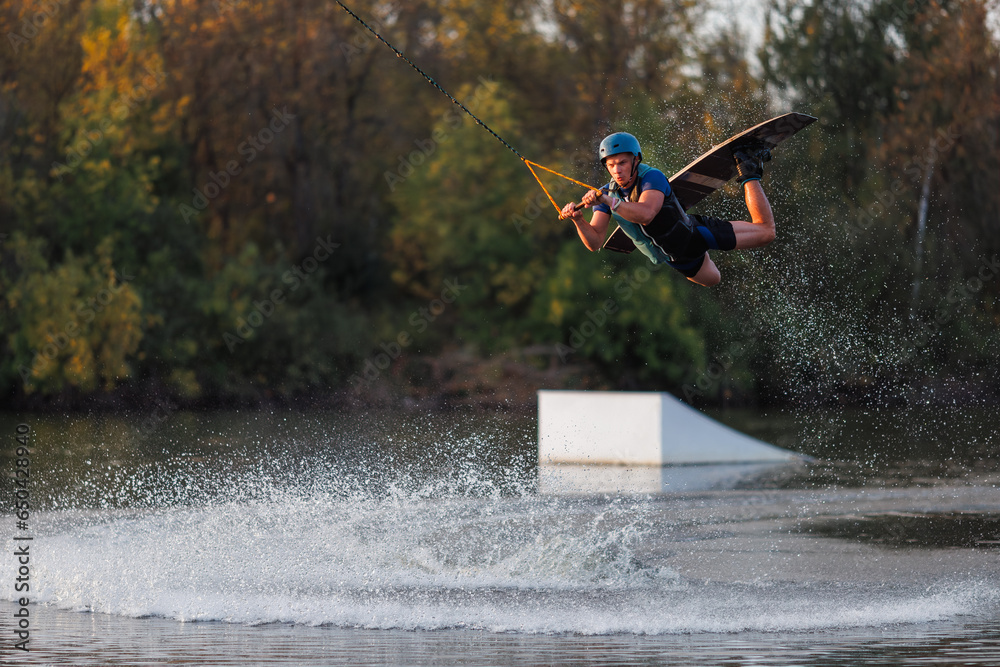 An athlete does a trick from a springboard. A rider jumps on a ...