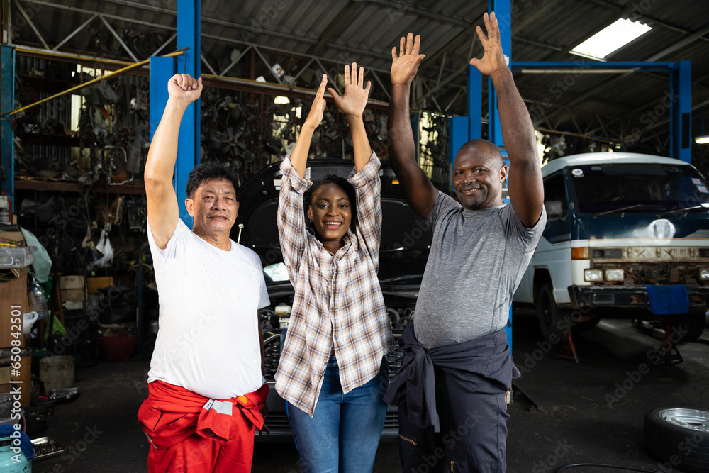 portrait of garage owner and mechanic team raise hand celebrate win ...