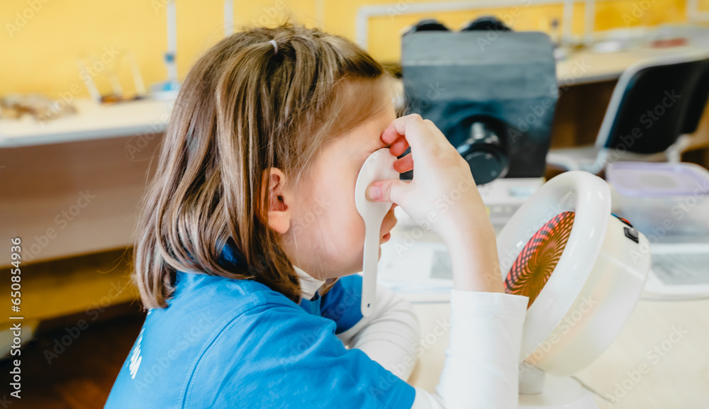 Little girl in medical office undergoing advanced laser vision ...