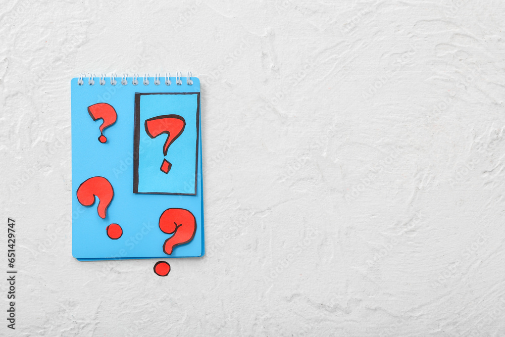 Notebook with quiz card and question marks on white background Stock ...