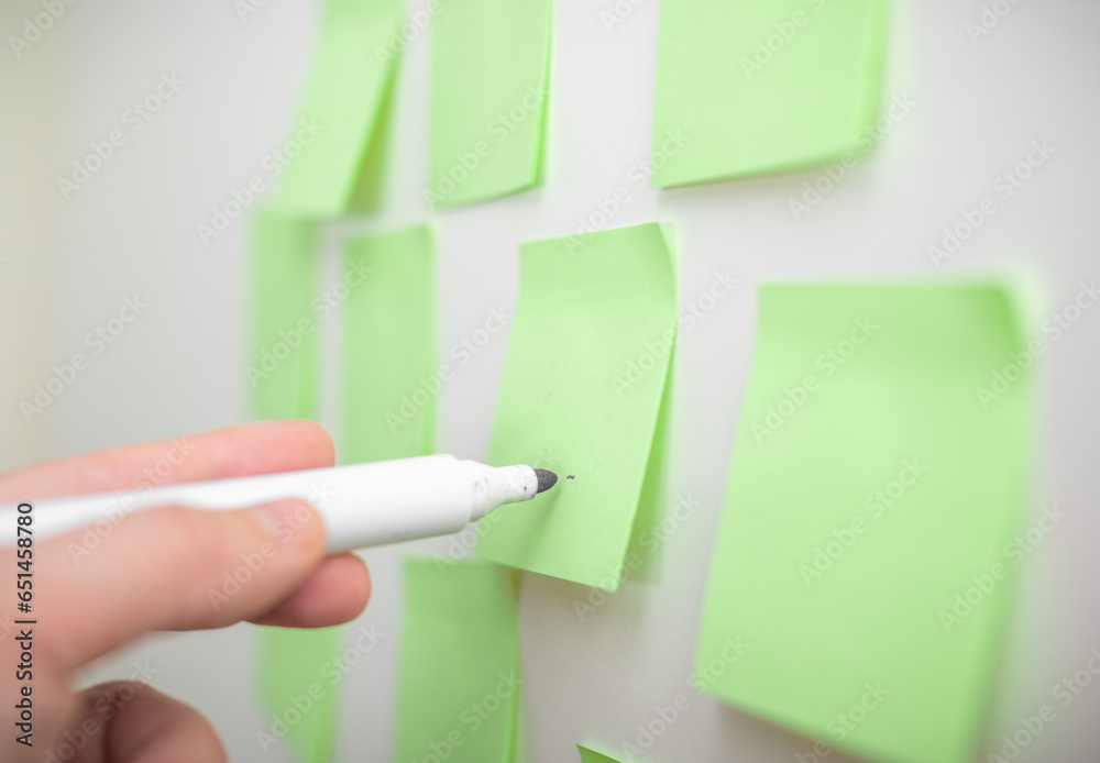 Brainstorming for strategy plan. hand with marker writes on note. green ...