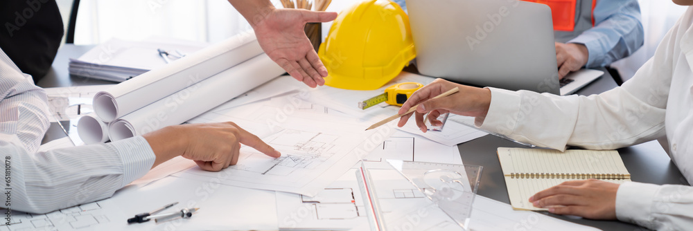 Engineer partner drawing and working on blueprint design together on ...