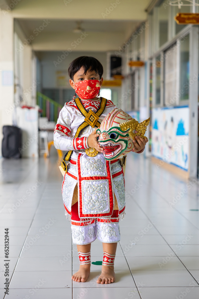 Happy and smile Asian boy wearing Hanuman Khon. Hanuman is Thailand ...