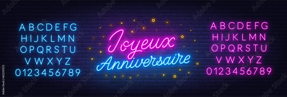 Joyeux Anniversaire neon lettering on brick wall background. Happy ...