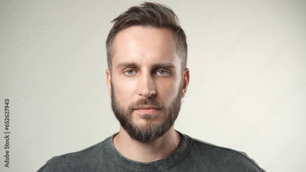Handsome person look at camera close up. Young adult man face portrait ...
