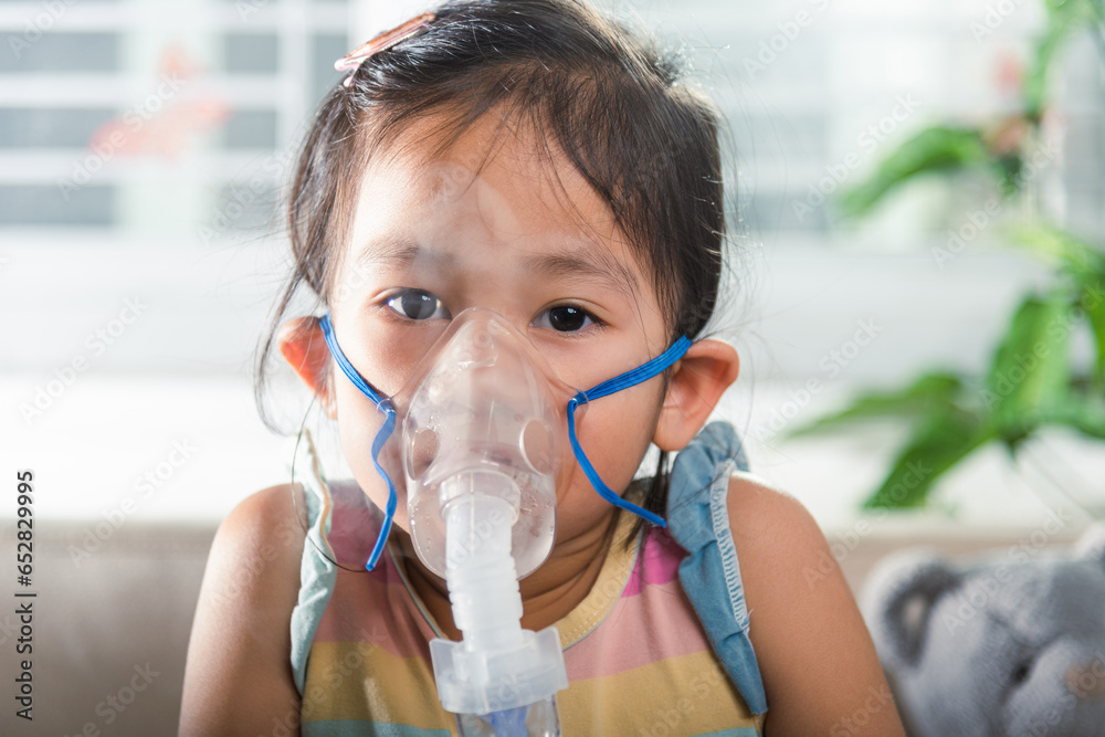 Kid girl making makes inhalation nebulizer steam sick cough at home ...