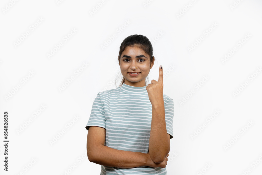 Young Indian girl smiling and pointing after casting her vote, isolated ...