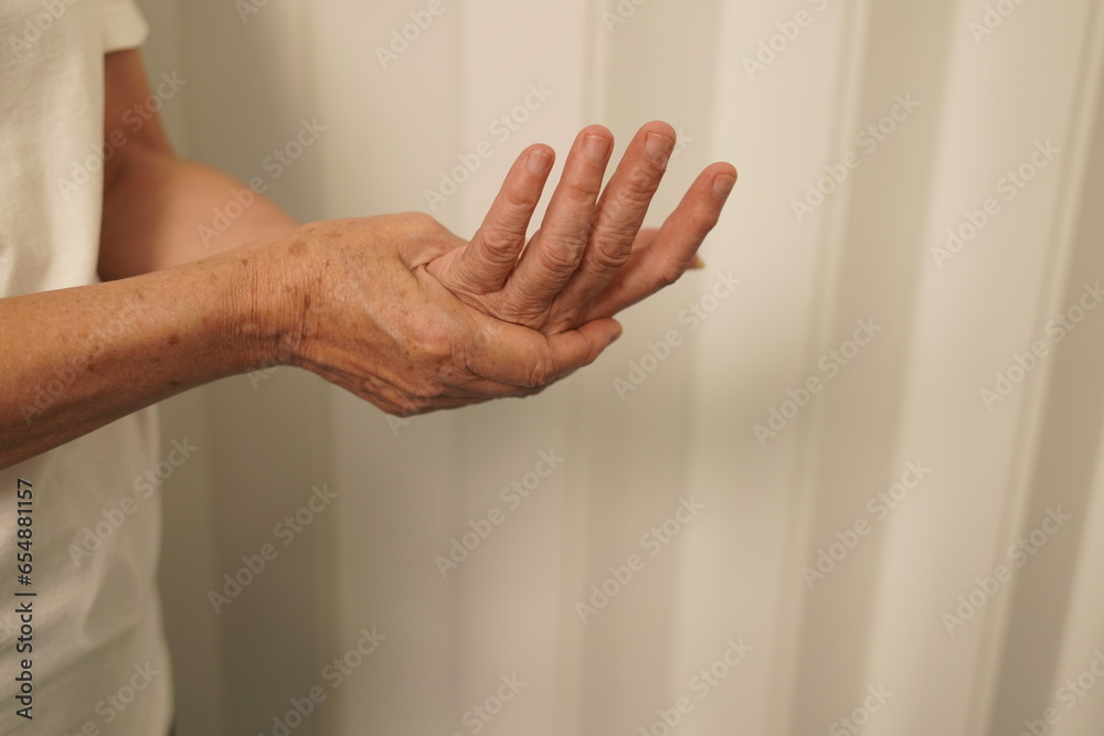 Stock-Foto „A woman uses her other hand to feel pain and tingling ...