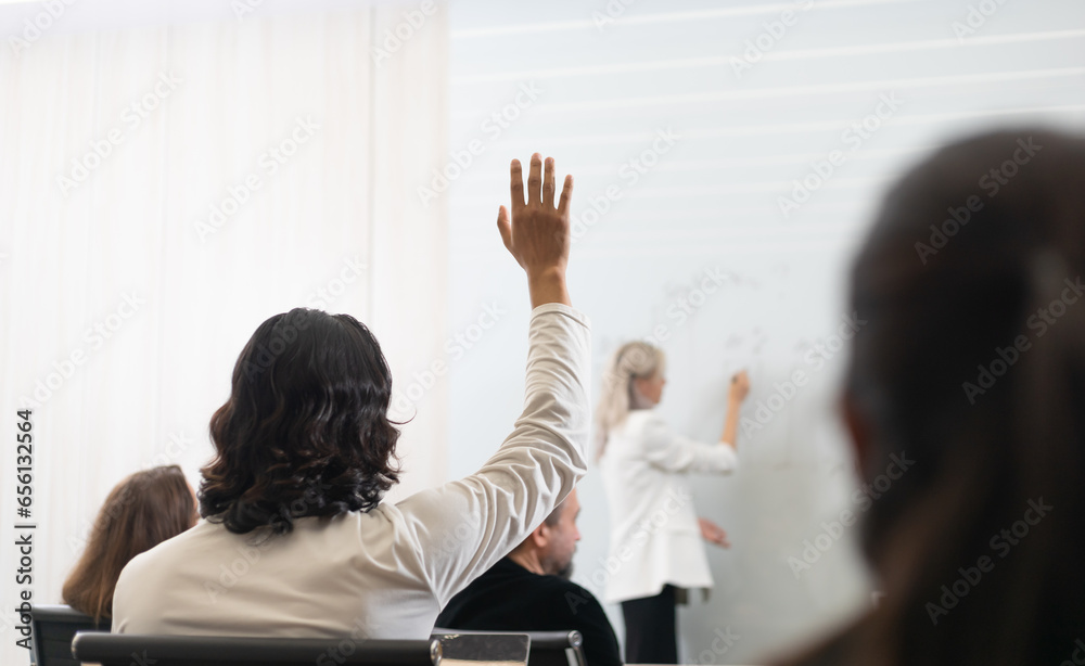 Businessman rises hand up for the question in the diverse employees ...