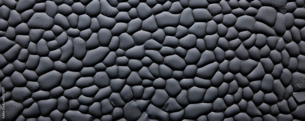 Closeup of a pebbled rubber texture, resembling a rough, dimpled ...