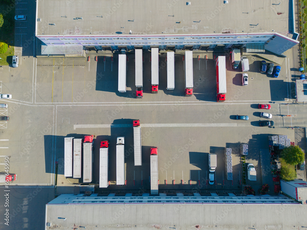 Logistics park with warehouse. Semi-trailers trucks standing on car ...