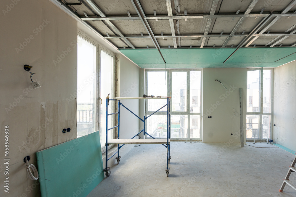 Drywall installation work in progress by construction workers at ...