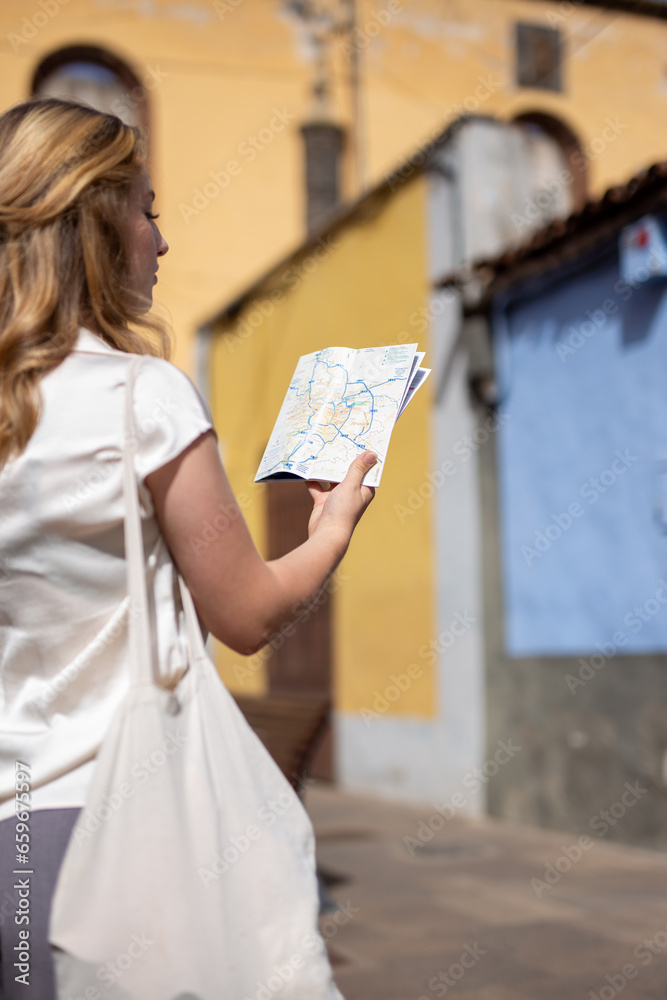 Young tourist using paper map locating tourist sites Stock Photo ...