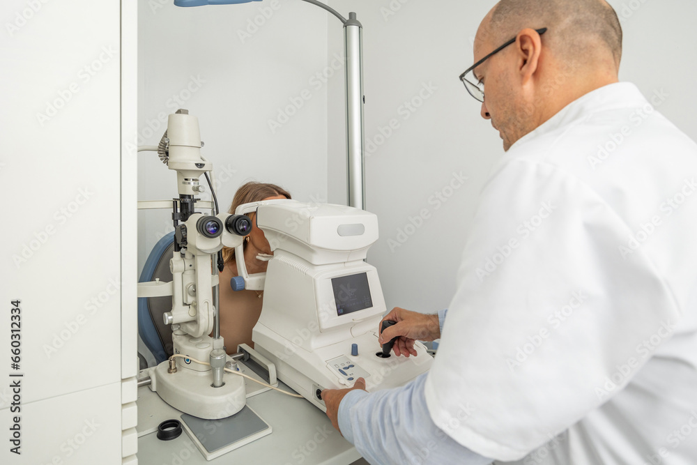 Eye exam and vision testing. Doctor performing the vision tests Stock ...